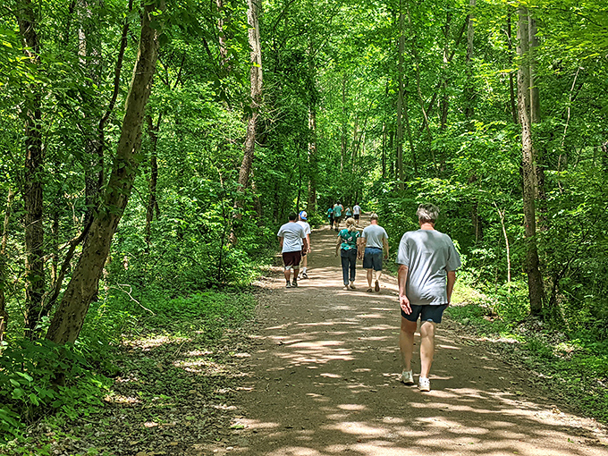 The path less traveled becomes considerably more traveled on sunny days. These hikers enjoy the dappled sunlight of the Moonville Rail Trail, blissfully unaware of what lurks after dark.