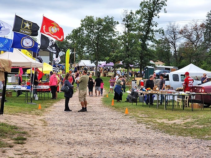 Military flags wave proudly at Adams Flea Market where treasure hunting becomes a patriotic duty. The hunt is on!