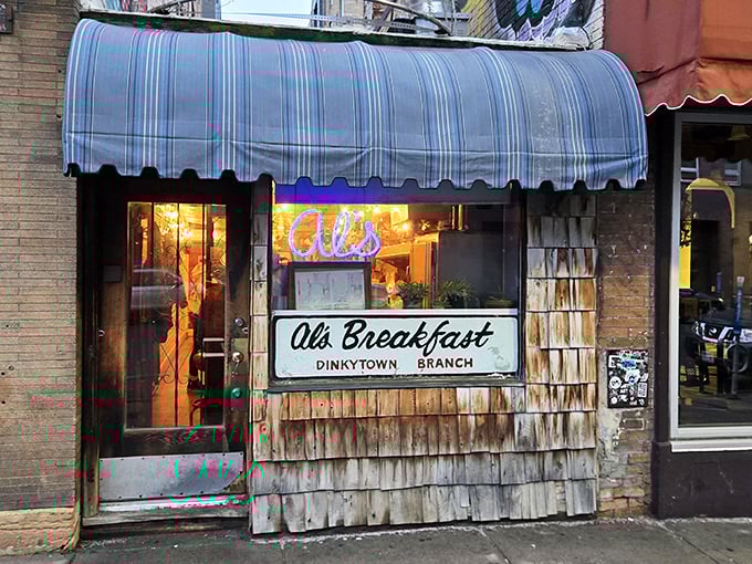 The iconic blue-striped awning of Al's Breakfast - where Dinkytown's tiniest diner serves up Minneapolis's biggest flavors.