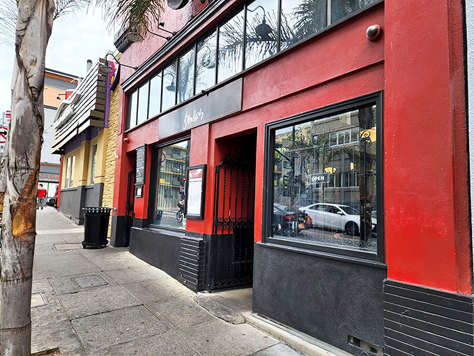 The vibrant red exterior of Brenda's stands out like a culinary exclamation point in San Francisco's Tenderloin. Soul food paradise awaits behind those doors.