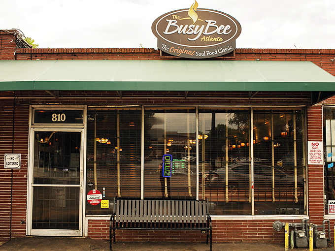 The Busy Bee Cafe storefront stands proudly on MLK Drive, a humble brick guardian of Atlanta's soul food legacy.