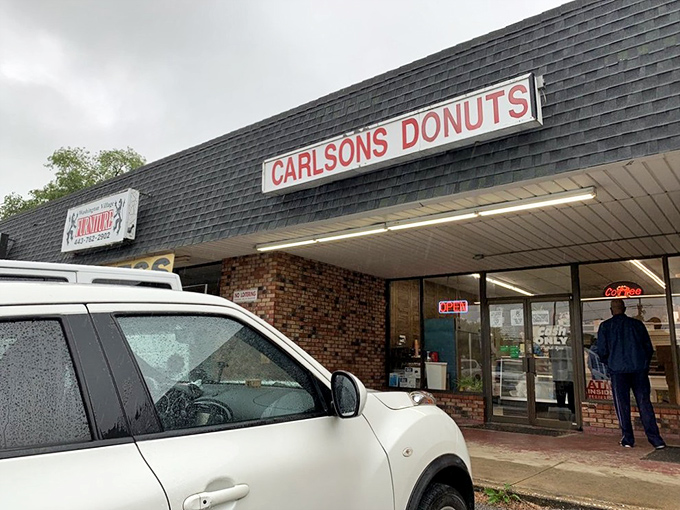 Carlson's Donuts exterior &ndash; where the no-frills brick fa&ccedil;ade hides Maryland's unsung hero of fried dough. A glorious sugar sanctuary in strip mall disguise.