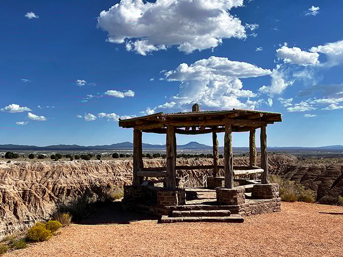 A rustic wooden gazebo stands sentinel at Cathedral Gorge's edge, like nature's perfect viewing platform for the most dramatic landscape you've never heard of.