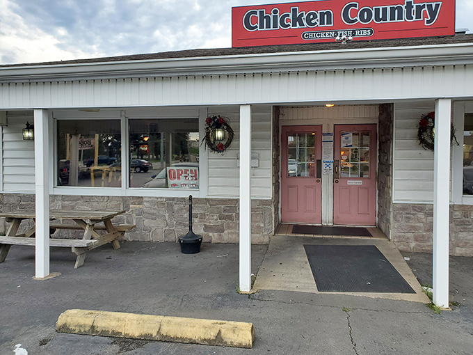 The unassuming entrance to Chicken Country&mdash;where culinary magic happens behind those pink doors and stone walls.