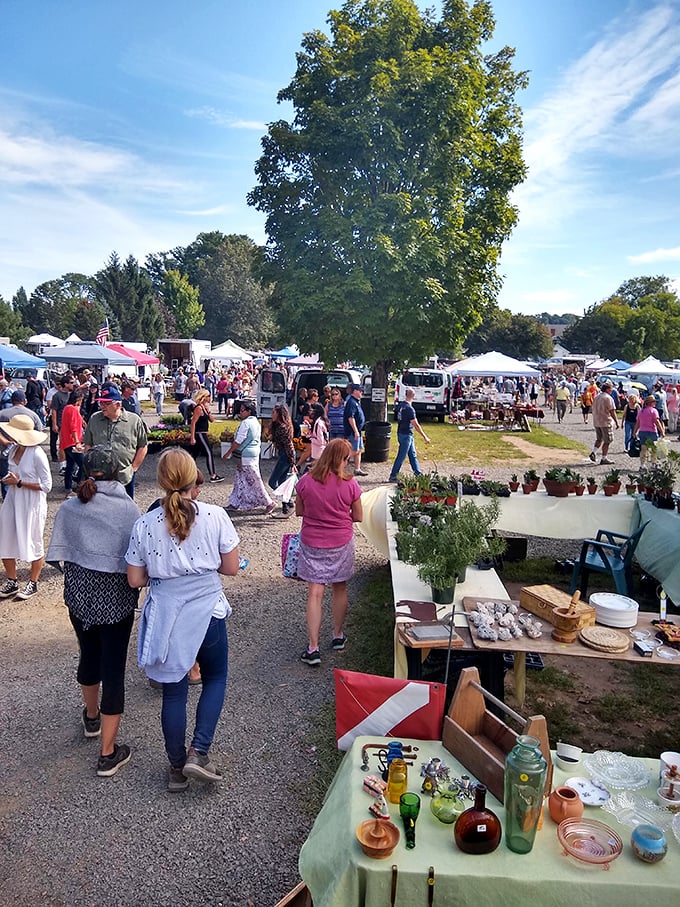 Treasure hunters paradise! The Elephant's Trunk Flea Market buzzes with activity under Connecticut's blue skies, a bargain-seeker's dream come true.