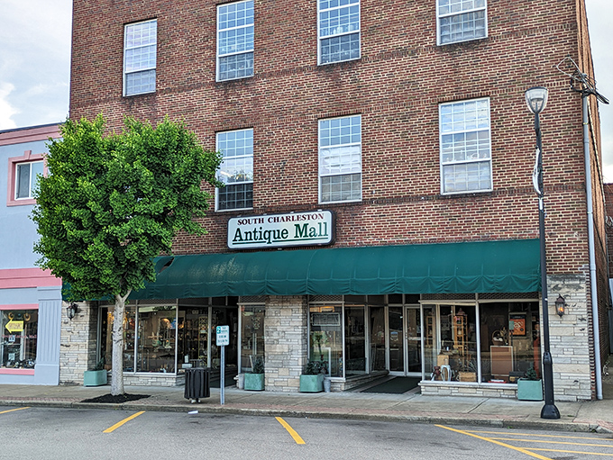 The South Charleston Antique Mall stands proud with its classic brick facade and inviting green awning &ndash; a time machine disguised as a building.