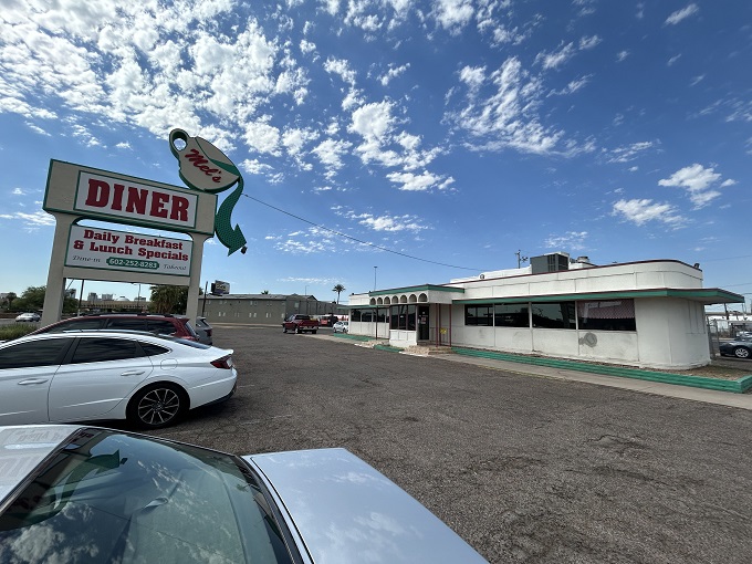 That vintage coffee cup sign isn't lying. At Mel's, your mug stays full while the morning regulars solve all the world's problems.