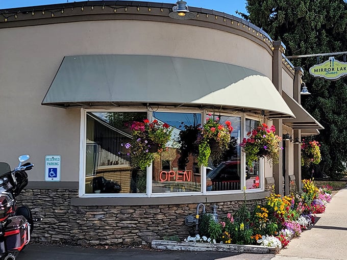 Mirror Lake Diner: Hanging flower baskets frame the "OPEN" sign like nature's own invitation to the best breakfast in Kamas.