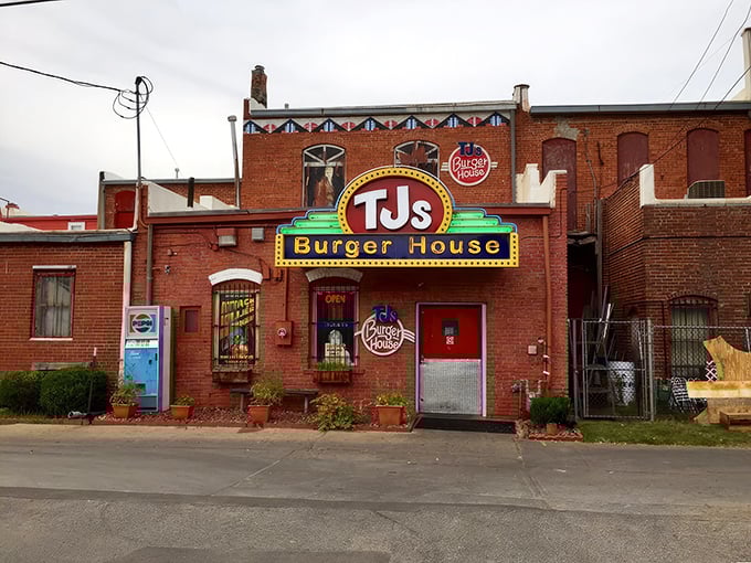 That glowing sign isn't just decoration&mdash;it's a beacon for burger lovers. TJ's classic exterior hides culinary treasures within those brick walls.