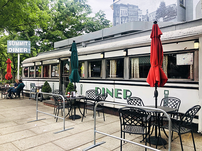 Outdoor seating at the Summit Diner: Where breakfast meets fresh air. Those red umbrellas aren't just for show &ndash; they're sheltering conversations that will last until lunch.