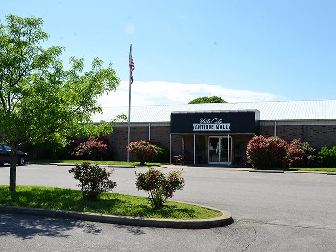 American flag flying proudly above this brick beauty &ndash; Vette City's flower-lined entrance promises adventures in nostalgia just beyond those doors.