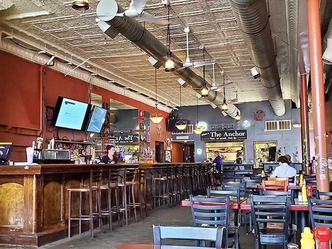 Industrial chic meets cozy tavern vibes &ndash; exposed ductwork and pressed tin ceilings create the perfect backdrop for serious eating. 