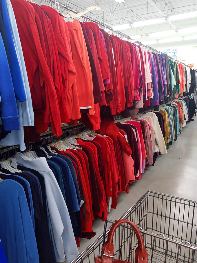 A rainbow explosion of red garments awaits treasure seekers. This isn't just a rack&mdash;it's a textile opportunity waiting to transform someone's wardrobe.