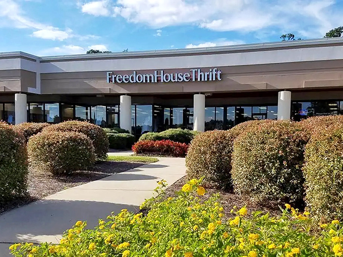 Manicured landscaping and welcoming columns frame the entrance, proving that secondhand shopping doesn't have to feel like a rummage through your neighbor's garage.