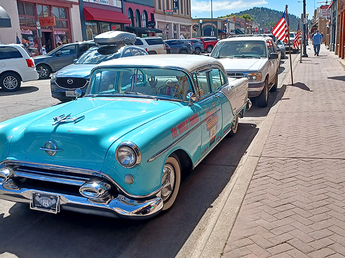 Classic American iron parked along a historic downtown. That turquoise beauty isn't just transportation&mdash;it's a time machine with whitewalls.