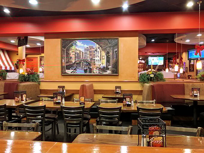 Venetian canal artwork and warm red walls create that perfect "fancy but not too fancy" atmosphere where both date nights and family dinners thrive.