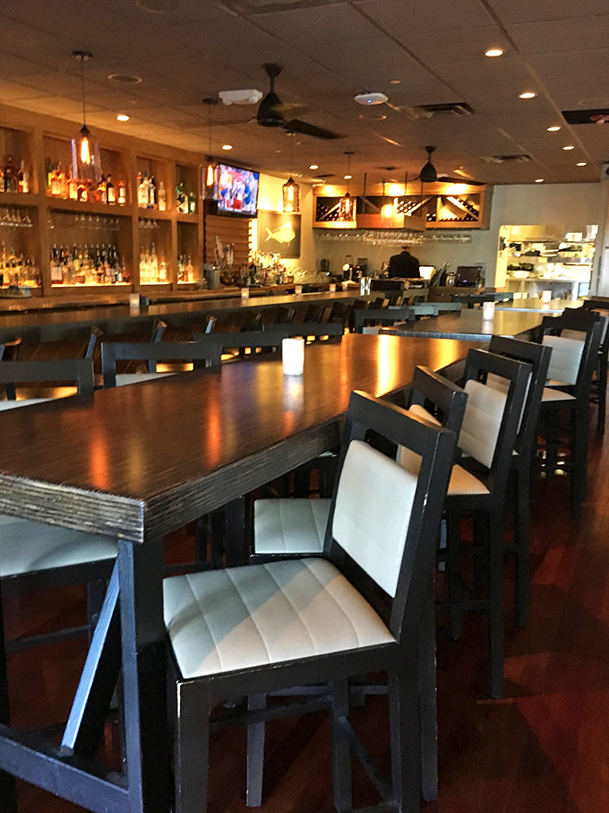 Modern meets rustic in Fred's dining area, where sleek white chairs and polished wood tables create the perfect stage for smoky masterpieces.