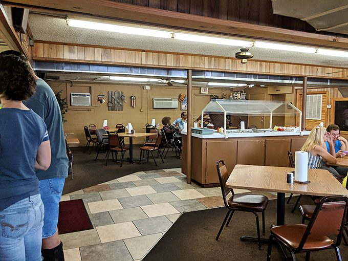 No-frills dining room where paper towels outrank cloth napkins and the wood paneling has witnessed more barbecue bliss than a thousand Instagram influencers.