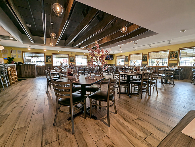 Warm yellow walls, wooden floors, and thoughtful lighting create that rare dining atmosphere where you feel both energized and relaxed simultaneously.