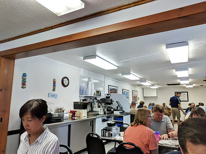 Inside, fluorescent lights and wooden beams create that classic diner atmosphere where conversations flow as freely as the coffee. No designer lighting needed when the food shines this bright.