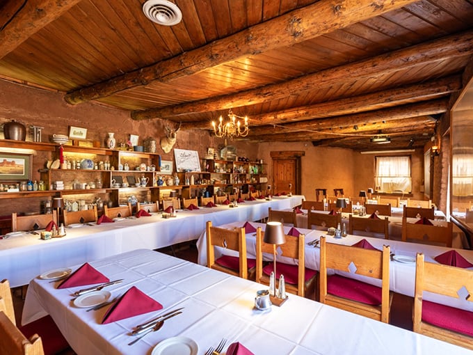 Exposed wooden beams and adobe walls create a dining room that whispers tales of frontier gatherings, where every meal becomes an expedition into Western heritage.