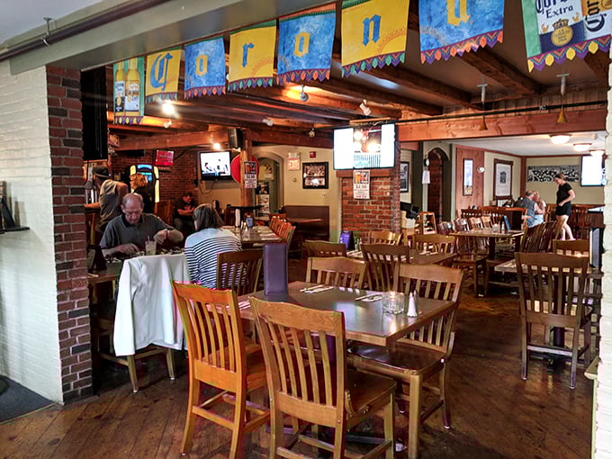 Exposed brick walls, wooden beams, and colorful banners create that perfect "come as you are, leave fuller" atmosphere that defines great neighborhood Italian spots.