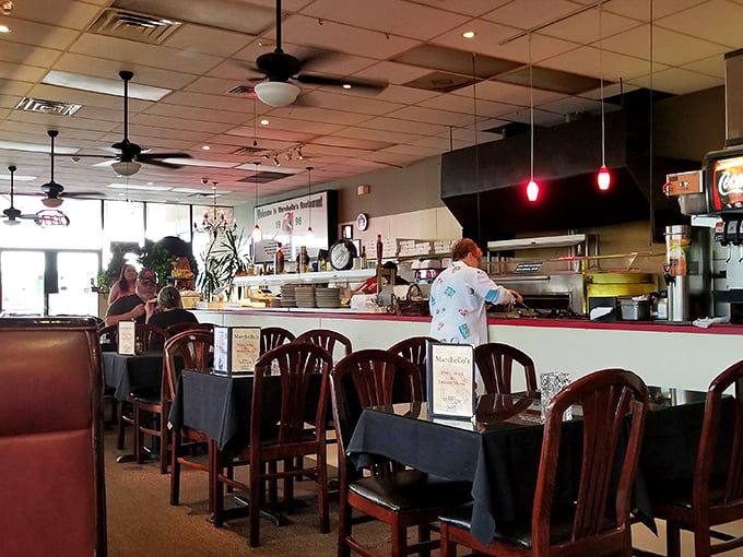 Inside, ceiling fans lazily spin above wooden chairs and dark tablecloths, creating that perfect "come as you are" atmosphere where memorable meals unfold.