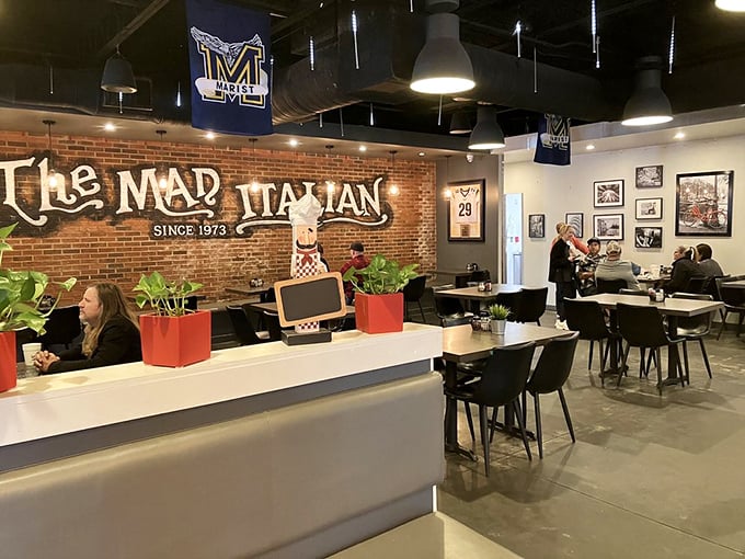 Inside, exposed brick meets modern comfort where local sports flags hang proudly above diners enjoying cheesesteaks worth breaking training for.