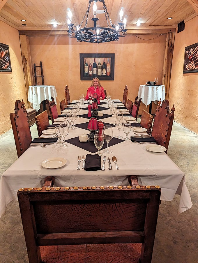 Private dining that whispers "special occasion." Red accents pop against warm wood walls, while that chandelier casts the kind of light that makes everyone look famous.