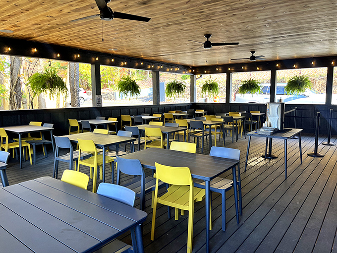 Yellow and blue chairs pop against wooden decking on this inviting porch. Mother Nature's dining room with ceiling fans for those humid West Virginia afternoons.