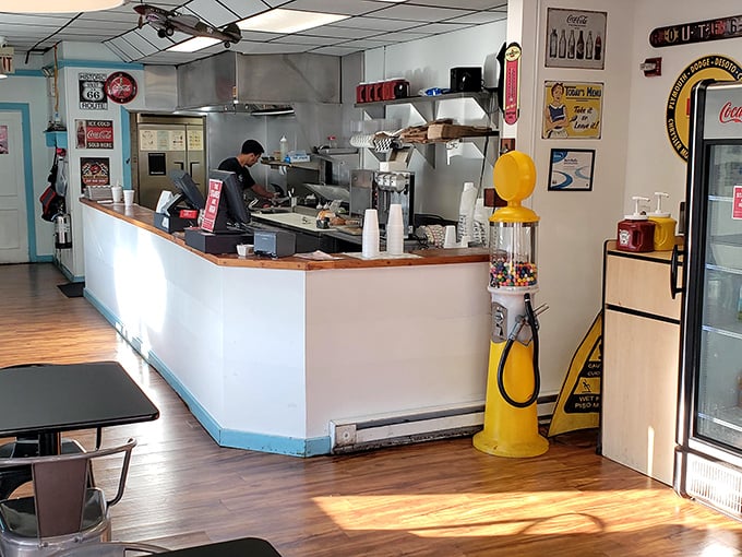 Metal chairs, wooden tables, and walls plastered with Route 66 memorabilia—this isn't interior design, it's time travel with a side of comfort food.