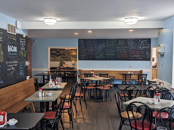 Sunlight streams through large windows, illuminating a dining room where blue walls and chalkboard menus create the perfect backdrop for morning revelations.