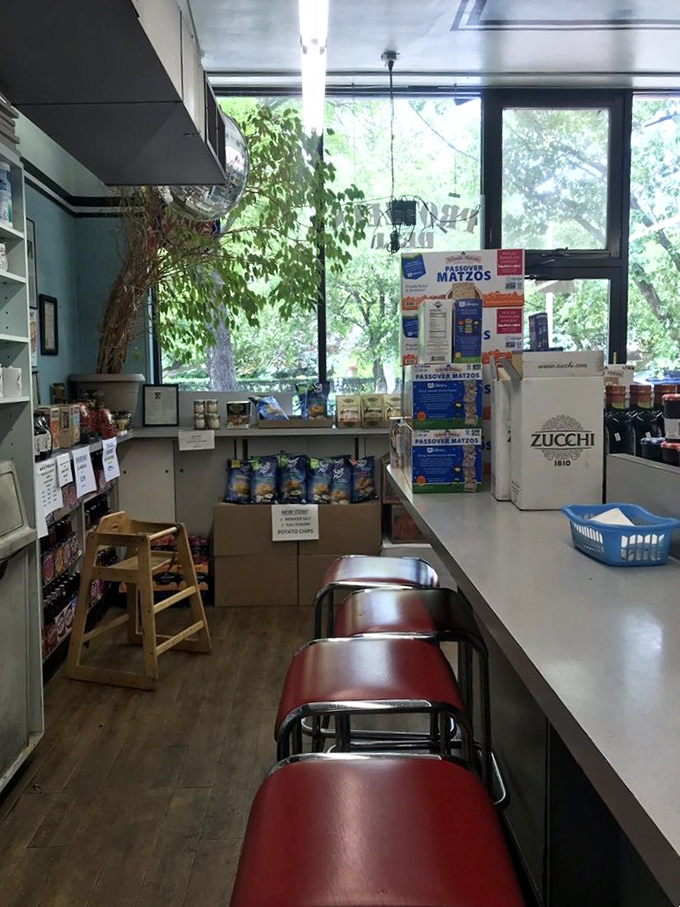 Red counter stools await deli pilgrims while shelves overflow with specialty foods. It's like stepping into your favorite uncle's pantry.