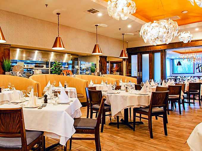 Copper pendants cast a warm glow over white tablecloths and caramel-toned booths &ndash; like dining in a jewelry box designed for serious meat enthusiasts.