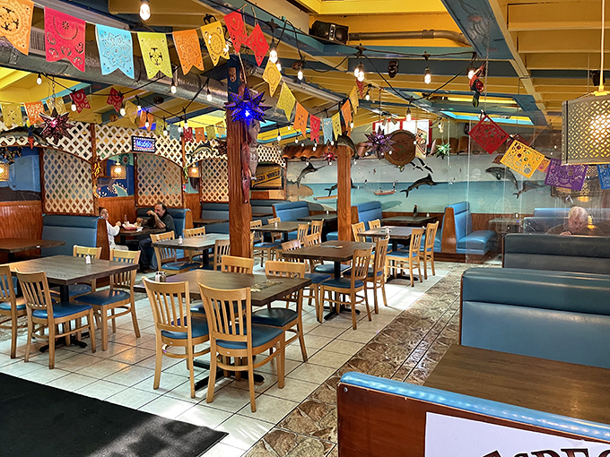 Colorful papel picado flags dance overhead while blue booths invite you to settle in for a fiesta. This isn't decoration&mdash;it's a warm Mexican embrace.