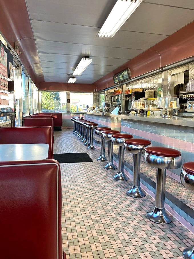 Chrome counter stools await hungry time travelers while cherry-red booths promise comfort&mdash;this isn't just seating, it's a front-row ticket to American dining history.