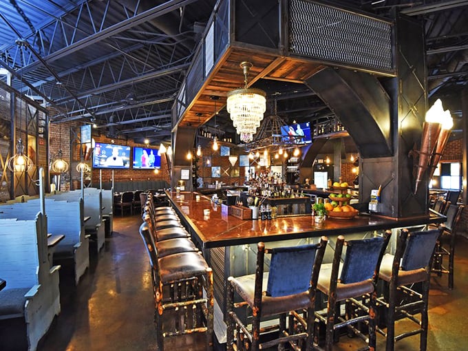 Industrial meets elegant in Le Moo's bar area, where crystal chandeliers hang above leather chairs. The perfect setting for bourbon sipping and deal-making.