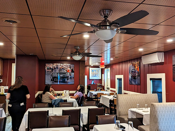 Burgundy walls, ceiling fans, and white tablecloths create that perfect "serious about food, not about pretension" atmosphere that makes regulars feel at home.