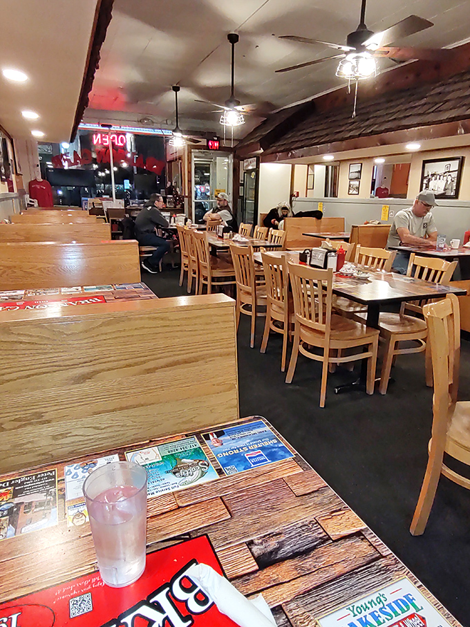 Simple wooden tables and chairs set the unpretentious stage where culinary magic happens. No fancy lighting required when the food shines this bright.