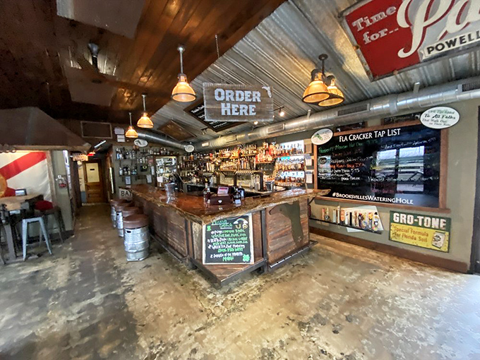 The bar area strikes that perfect balance between rustic charm and functional watering hole. That "Order Here" sign isn't kidding around&mdash;good things await.