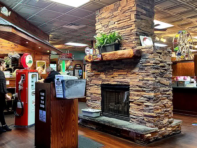 That stone fireplace isn't just for show&mdash;it's the beating heart of a dining room where vintage gas pumps and nostalgic memorabilia create the perfect steakhouse ambiance.