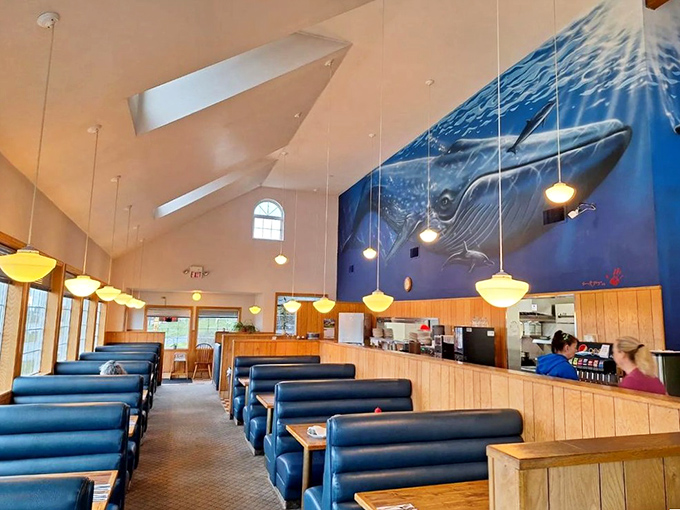 Navy blue booths and warm wood paneling create the perfect maritime-meets-cozy atmosphere, where breakfast dreams come true.