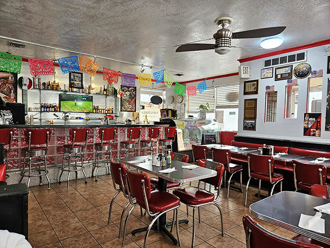 Inside, red vinyl booths and colorful papel picado banners create that perfect diner atmosphere where conversations flow as freely as the coffee.