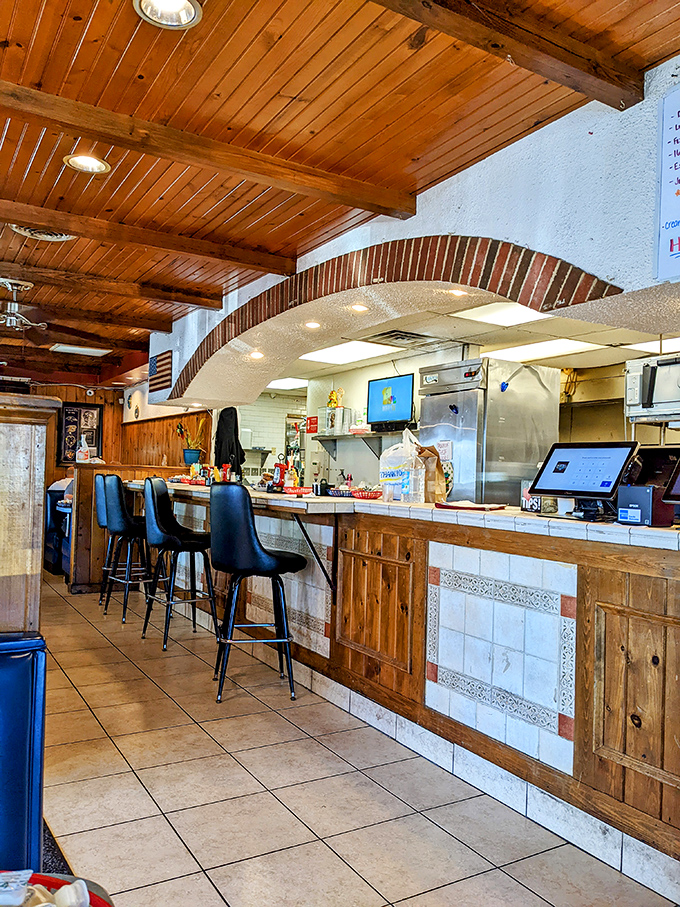 Wooden ceiling beams and classic counter seating create that "where everybody knows your name" vibe. The kitchen pass-through offers dinner and a show.
