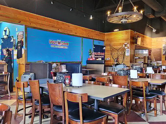 The rustic wooden interior with its wagon wheel chandelier says "coastal getaway" while the blue accent wall shouts "hey, we've got crab!"