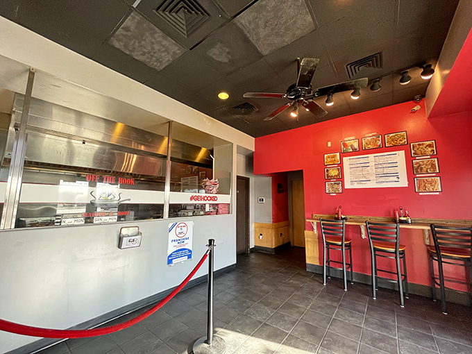 Red walls and counter seating create a no-nonsense atmosphere where the food takes center stage. Seafood theater in the round.
