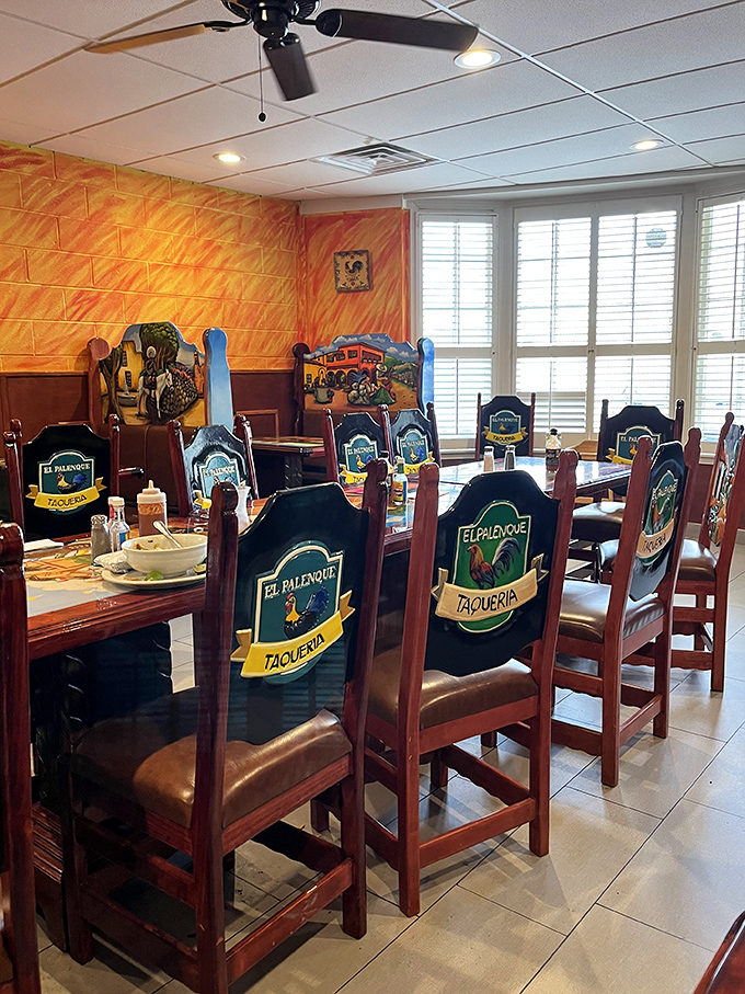 Wooden chairs emblazoned with the restaurant's logo surround tables where culinary magic happens daily. Comfort trumps pretension in this warm space.