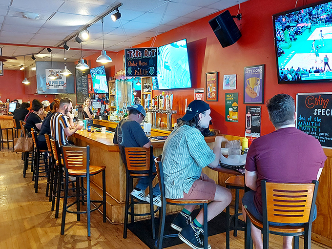 The lively bar scene at City Dogs proves that great food brings people together better than any social media platform ever could.