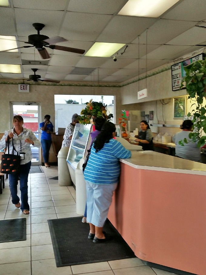 Inside, the pink counter and ceiling fans create a time capsule of Americana where conversations flow as freely as the sweet tea.