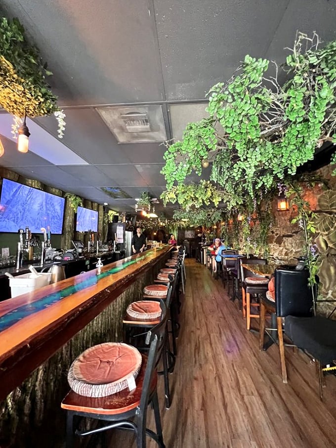 Greenery cascades from the ceiling, transforming a simple bar into a woodland canopy where cocktails seem infused with actual enchantment.